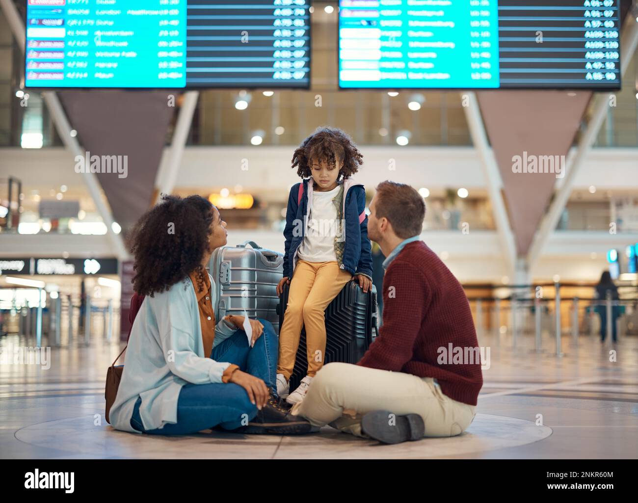 Family at airport, travel and wait with luggage, mother and father ...