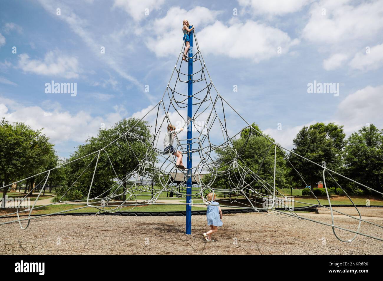 Children playing on triangular rope climbing frame Stock Photo - Alamy