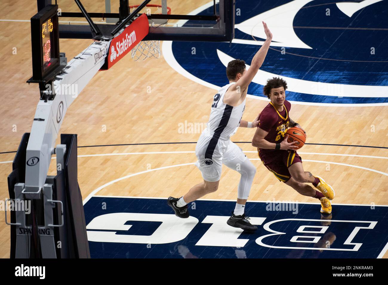 Minnesota guard Sean Sutherlin (24) dribbles past Penn State forward ...
