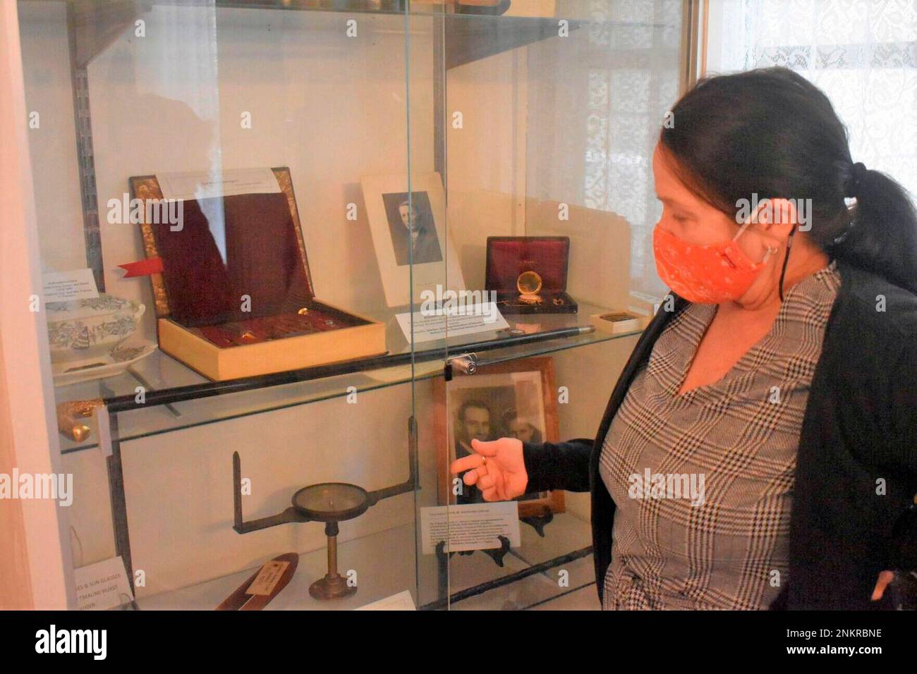 Susan Cook shows a display that contains various artifacts from ...