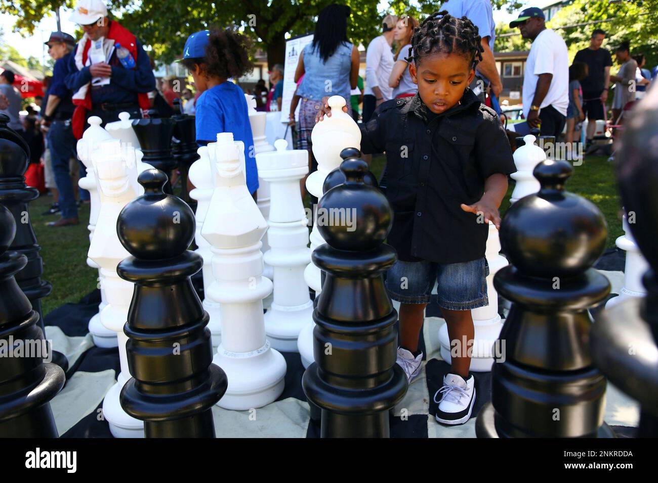 A boy plays with a giant chess set during a dedication ceremony for a ...