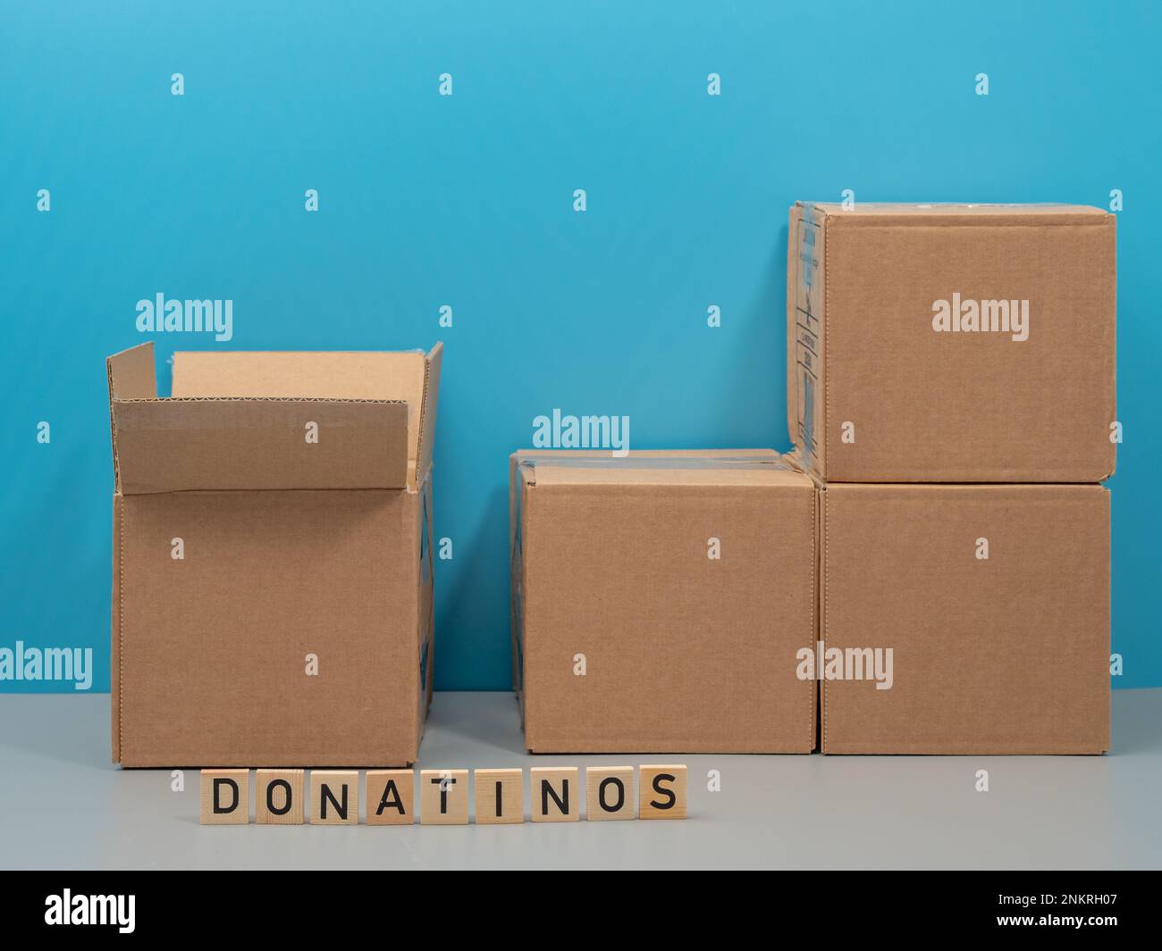Humanitarian aid. Cardboard boxes with donations on a blue background ...