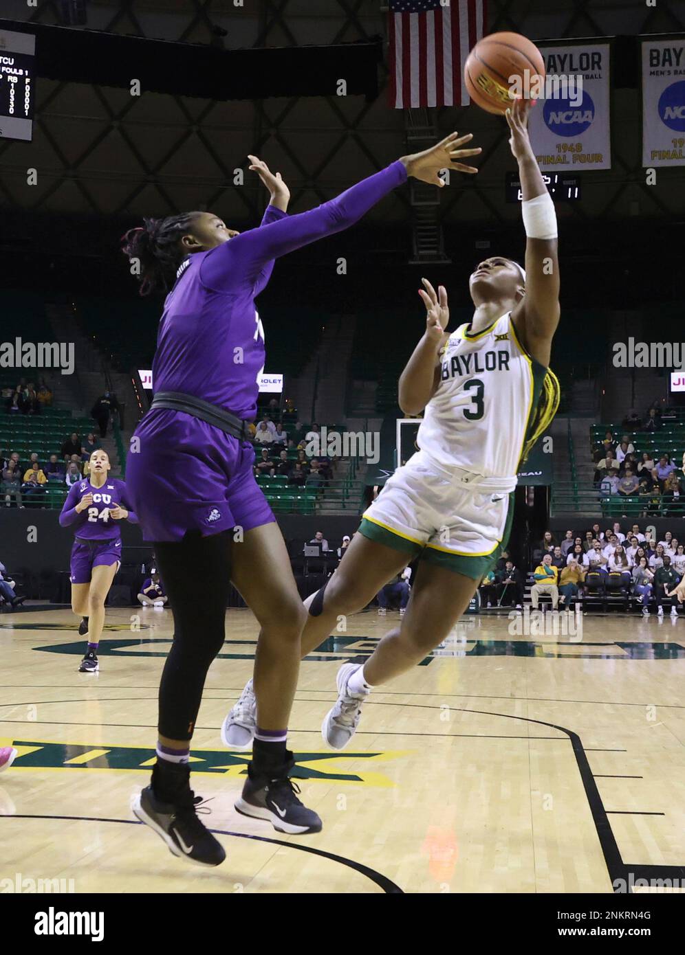 Baylor guard Jordan Lewis, right, shoots over TCU guard Okako Adika ...