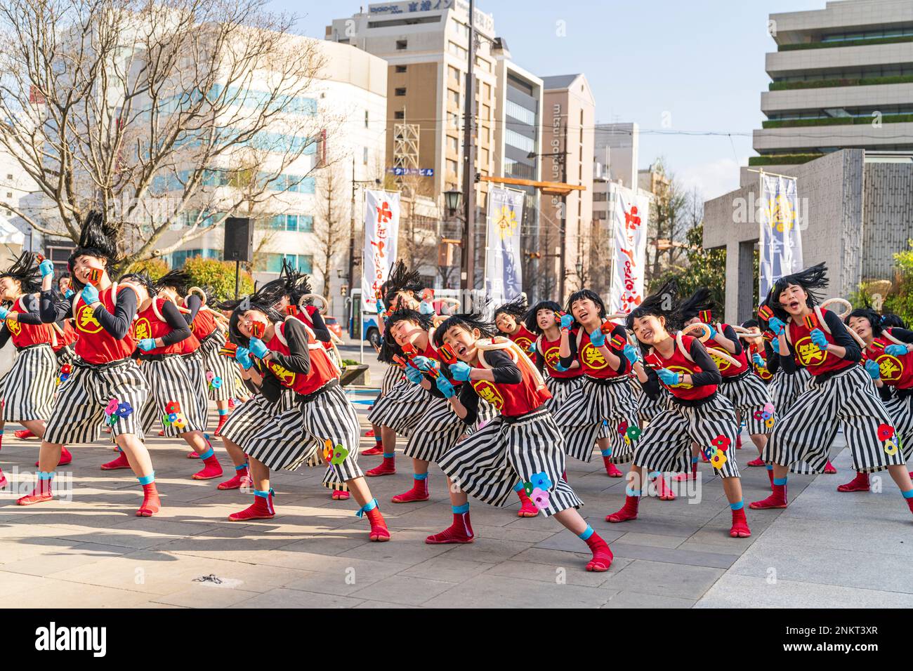 Japanese team of female child Yosakoi dancers dancing and holding ...
