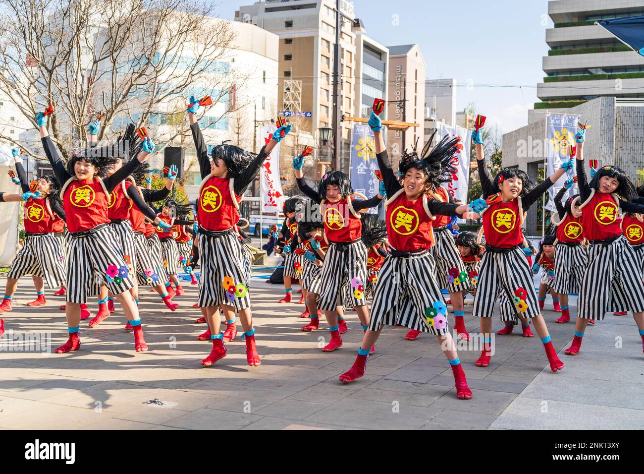 Japanese team of female child Yosakoi dancers dancing and holding ...