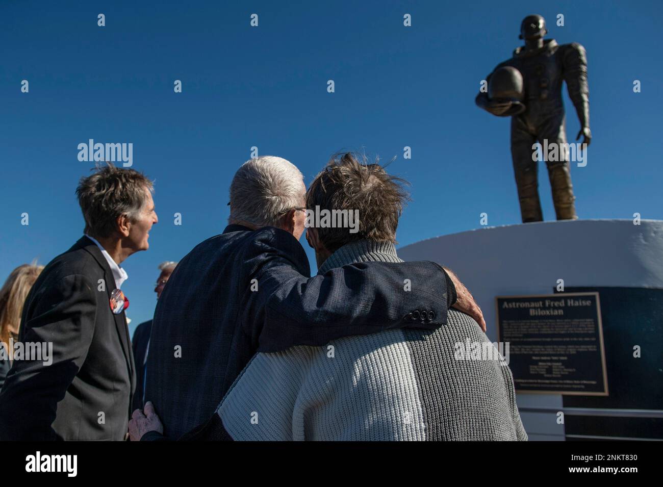 Apollo 13 astronaut Fred Haise Jr., center, hugs sculptor Mary Ott ...