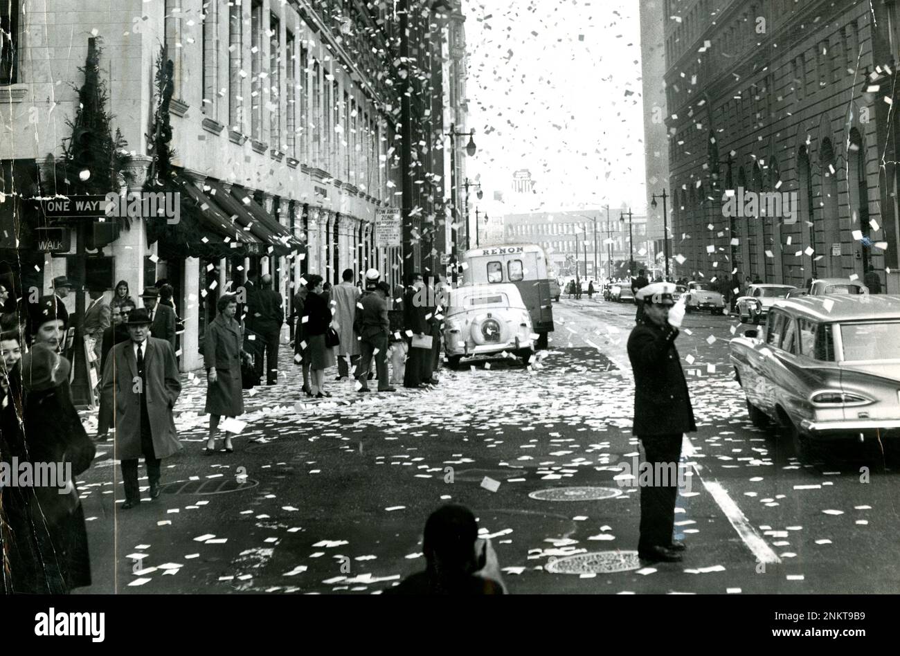 Paper rains down on a police officer on Market Street in San Francisco ...