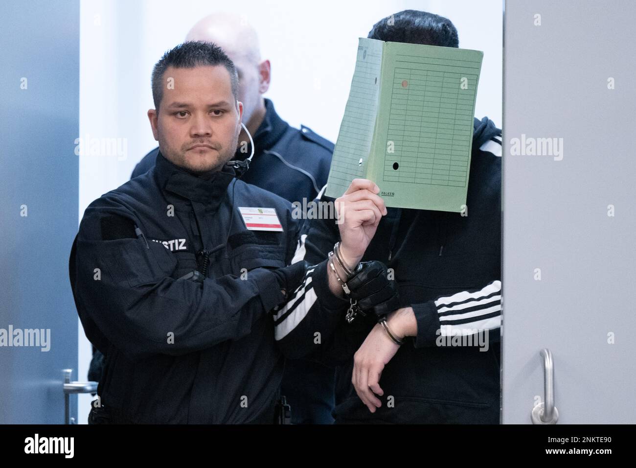 Dresden, Germany. 24th Feb, 2023. A defendant (r) in the trial of the ...