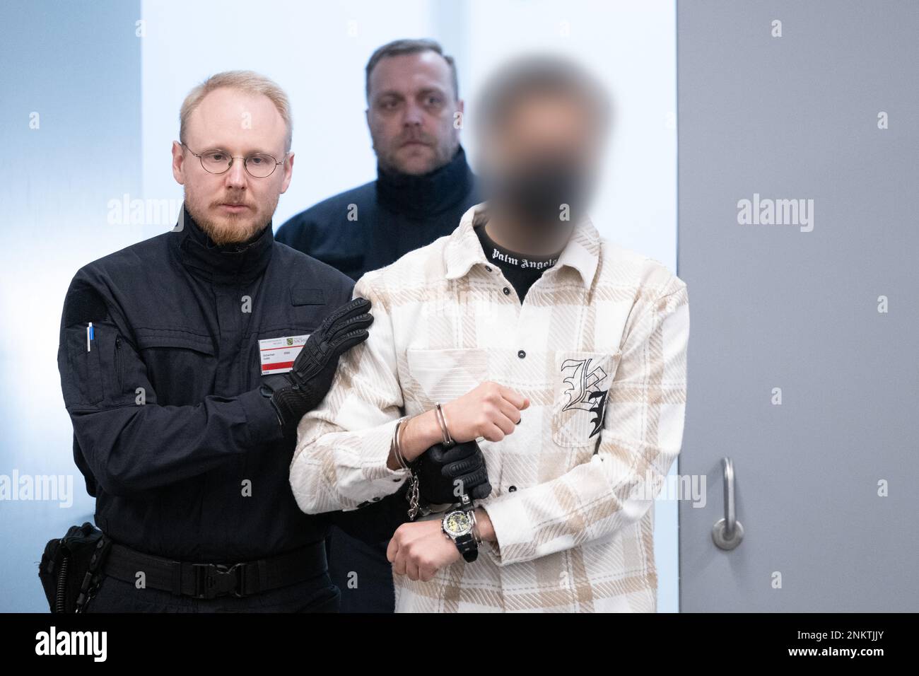 Dresden, Germany. 24th Feb, 2023. A defendant (r) in the trial of the ...