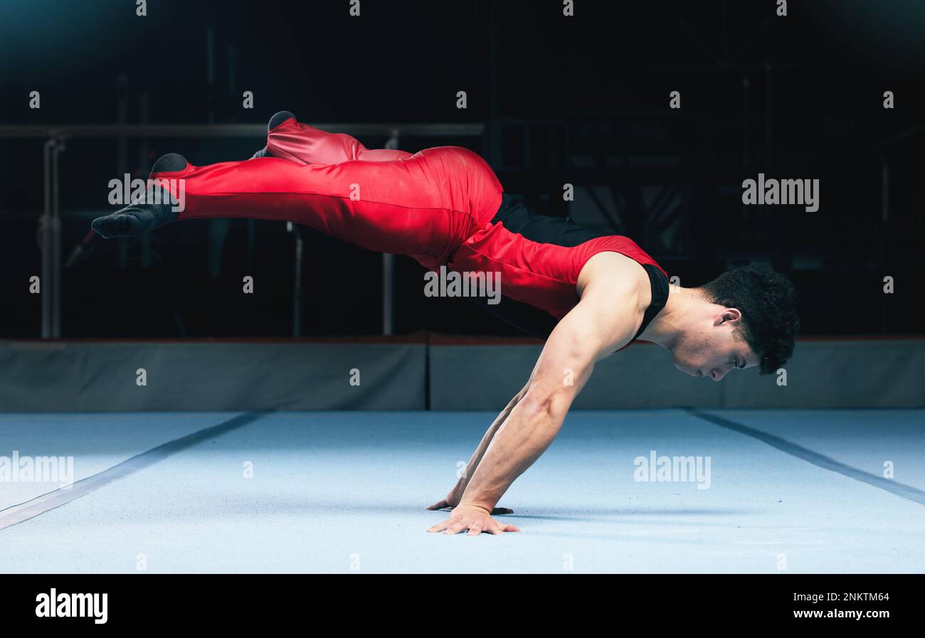 Gymnast, handstand and man on gym floor for training, balance and ...