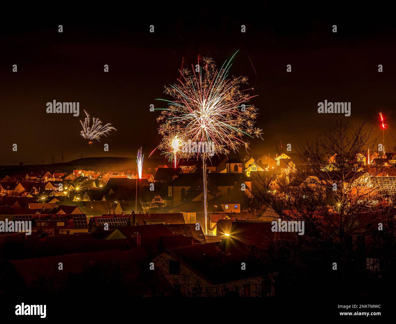 Firework over a small town Stock Photo - Alamy