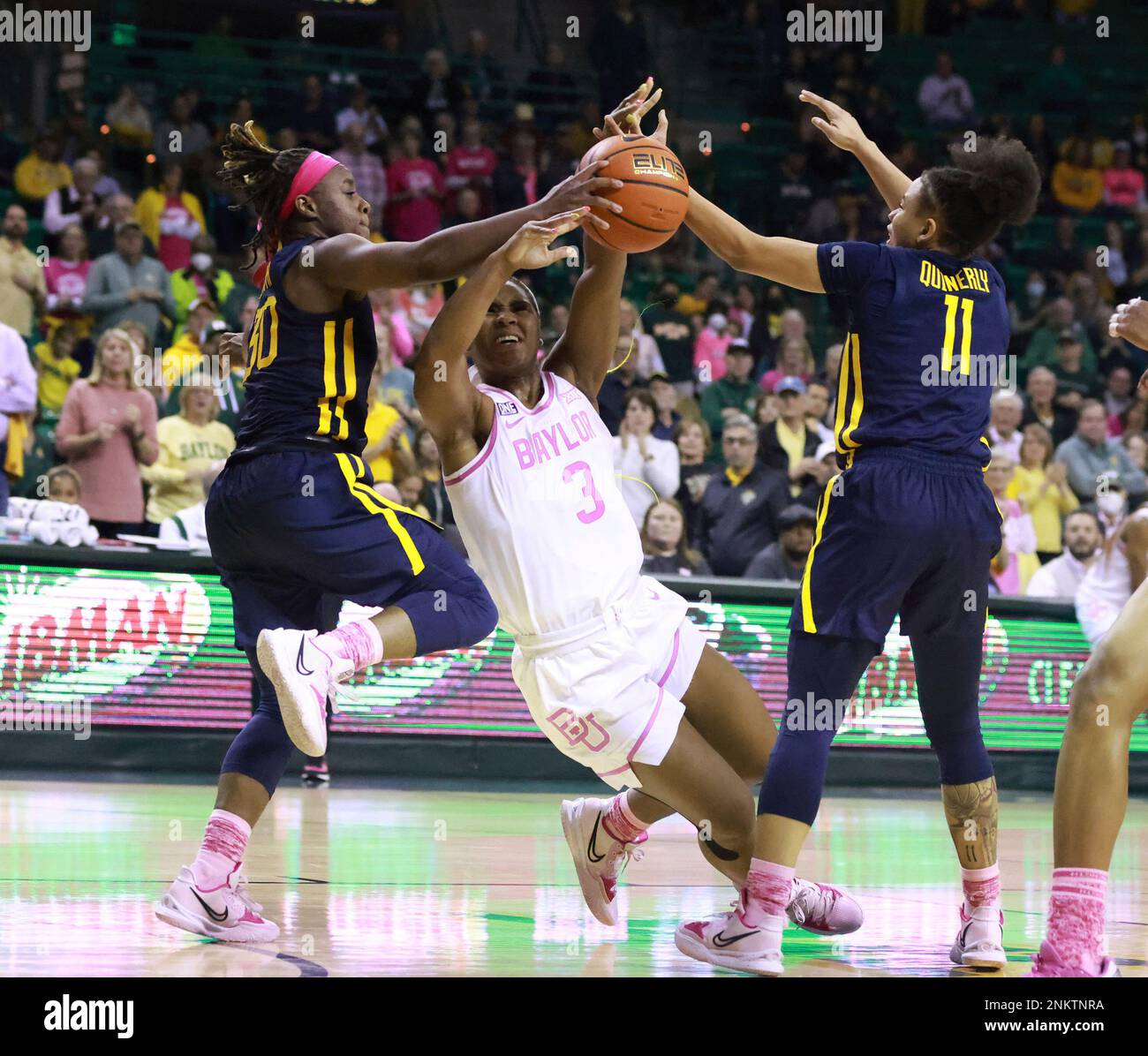 Baylor guard Jordan Lewis, center, loses her footing while being ...