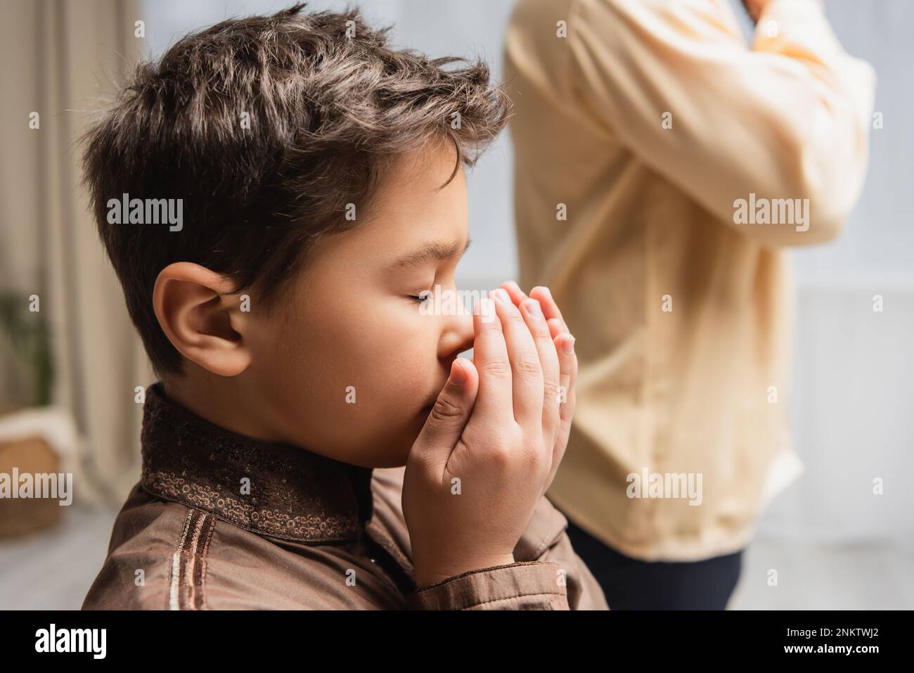 Muslim boy praying during salah and ramadan near dad at home,stock ...