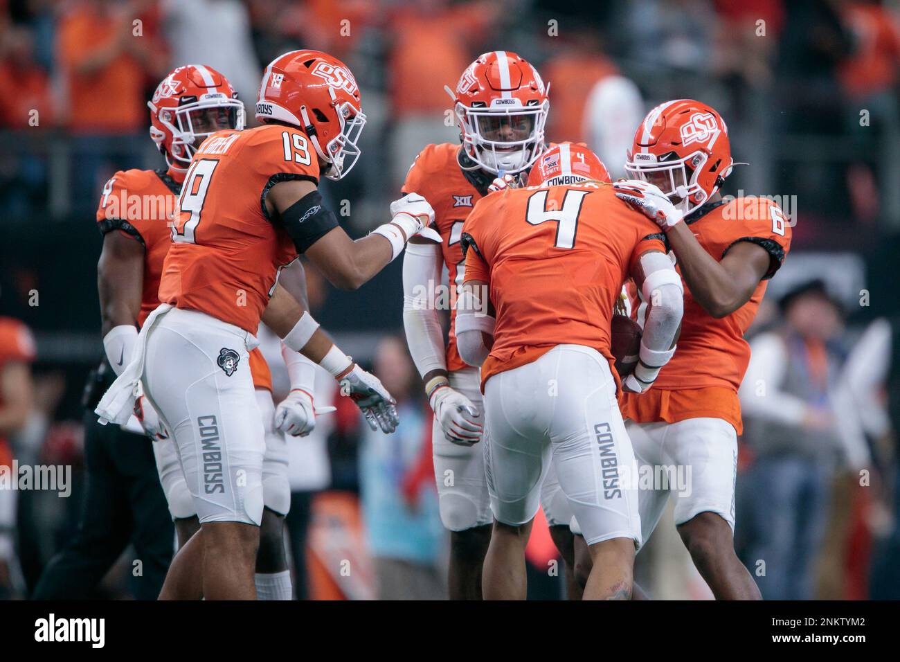 ARLINGTON, TX - DECEMBER 04: Oklahoma State Cowboys huddle on the field ...