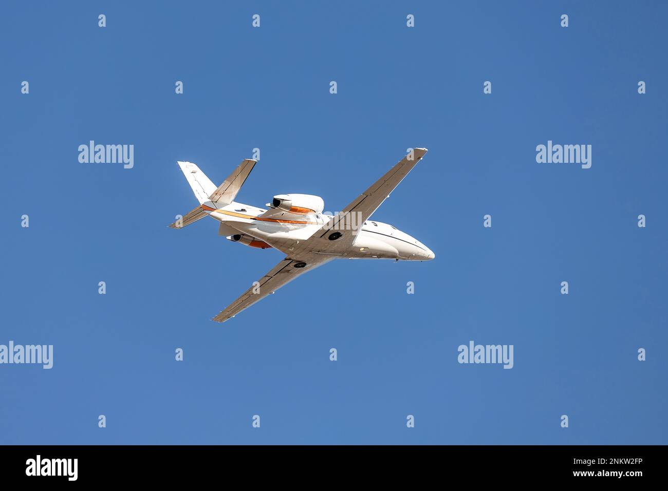 Scenic close bottom view modern luxury expensive white private jet ...