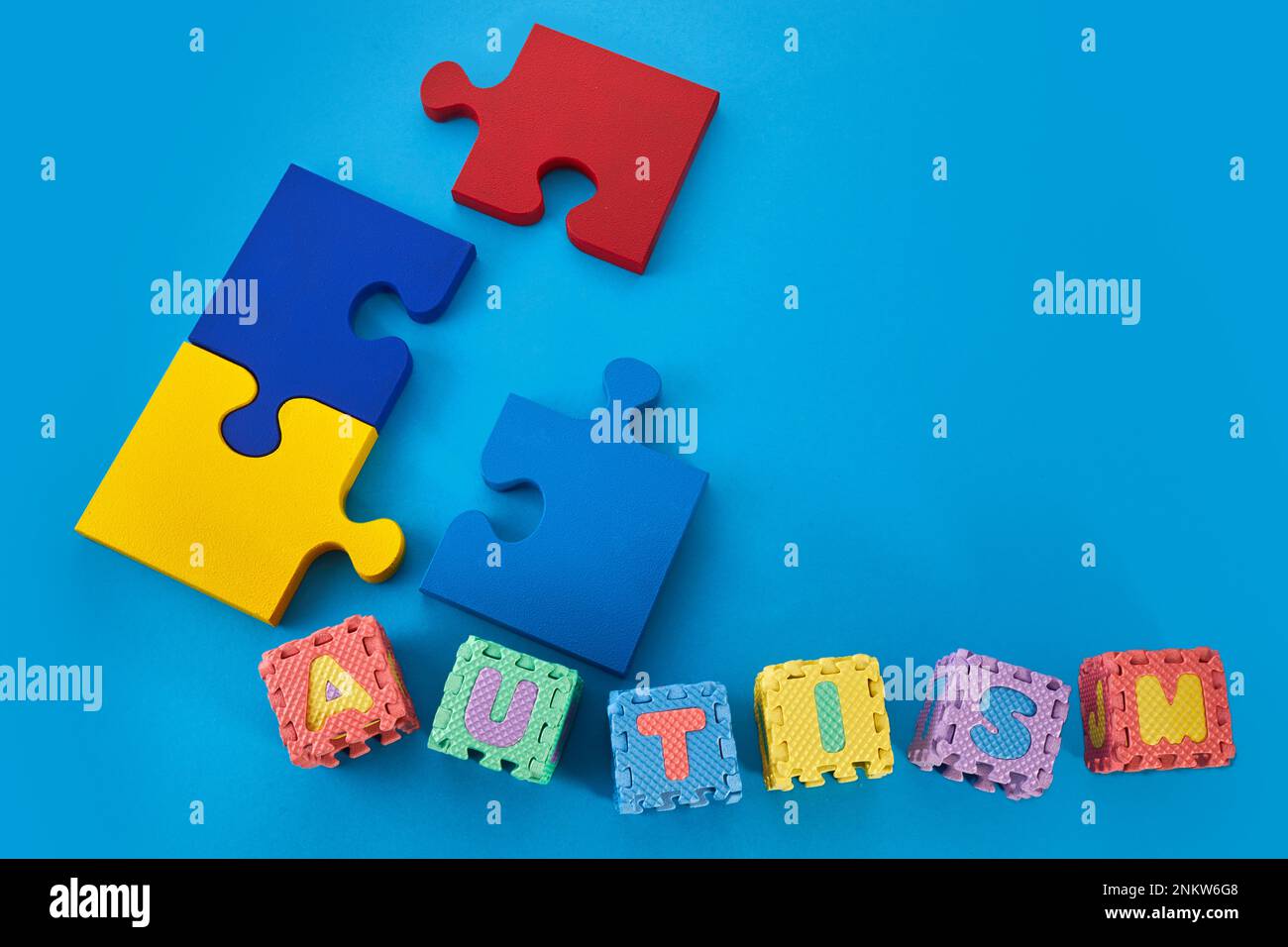 Word Autism on puzzle cubes on blue background. Autism awareness Stock ...