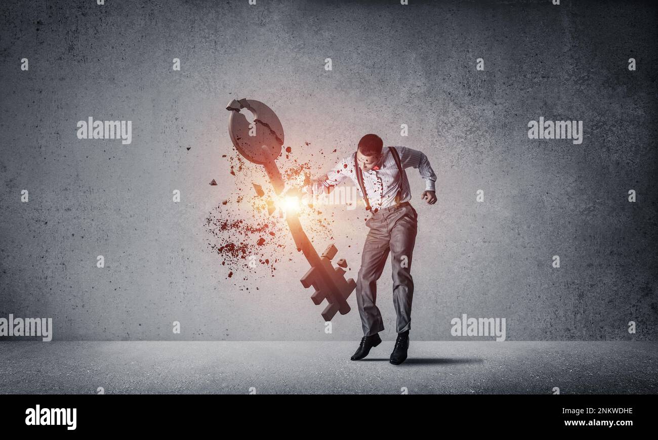 Breaking through access concept with man in room crashing concrete key ...