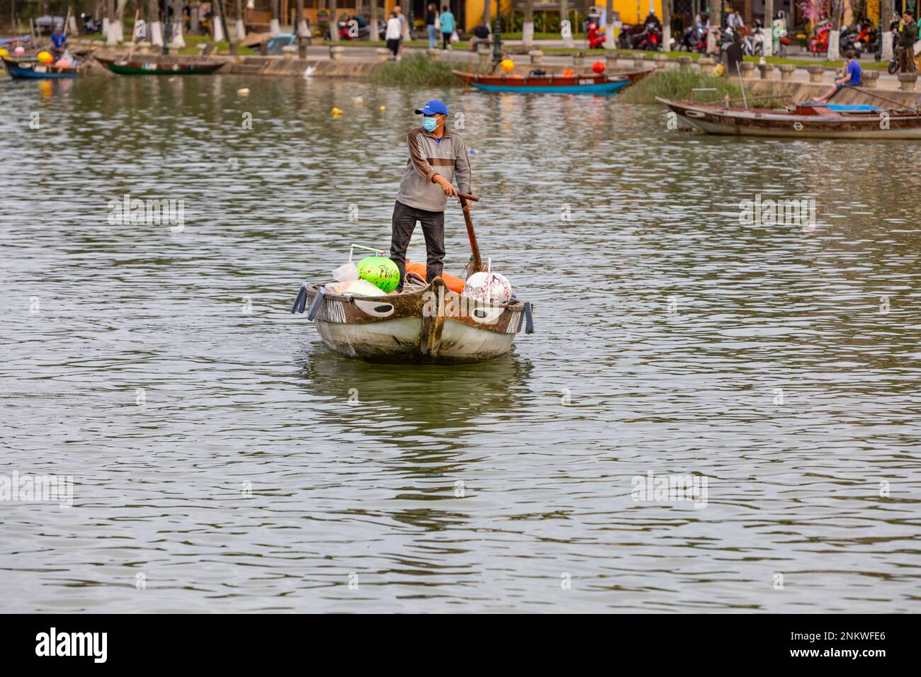 A man paddling a small boat on Thu Bon River in Hoi An, Vietnam Stock ...