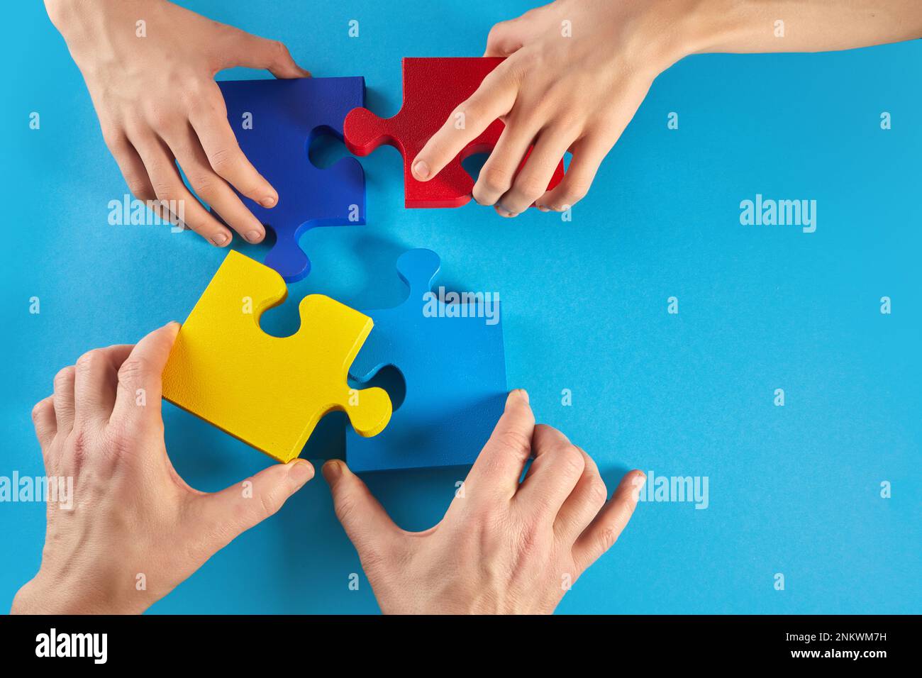 Father and autistic son hands holding jigsaw puzzle shape. World Autism ...