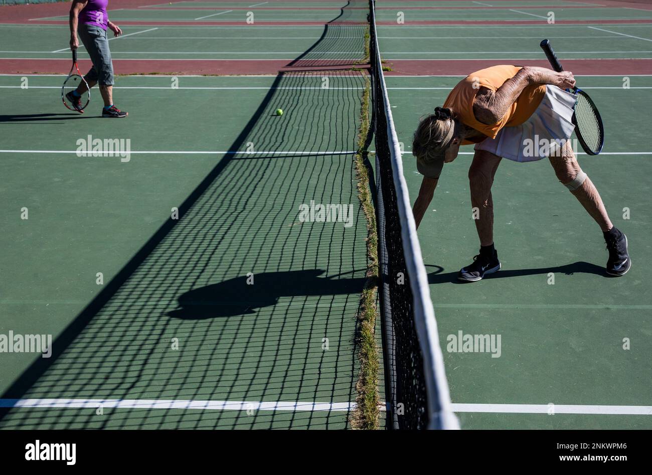 Florence Barich of San Francisco retrieves the ball while playing a ...