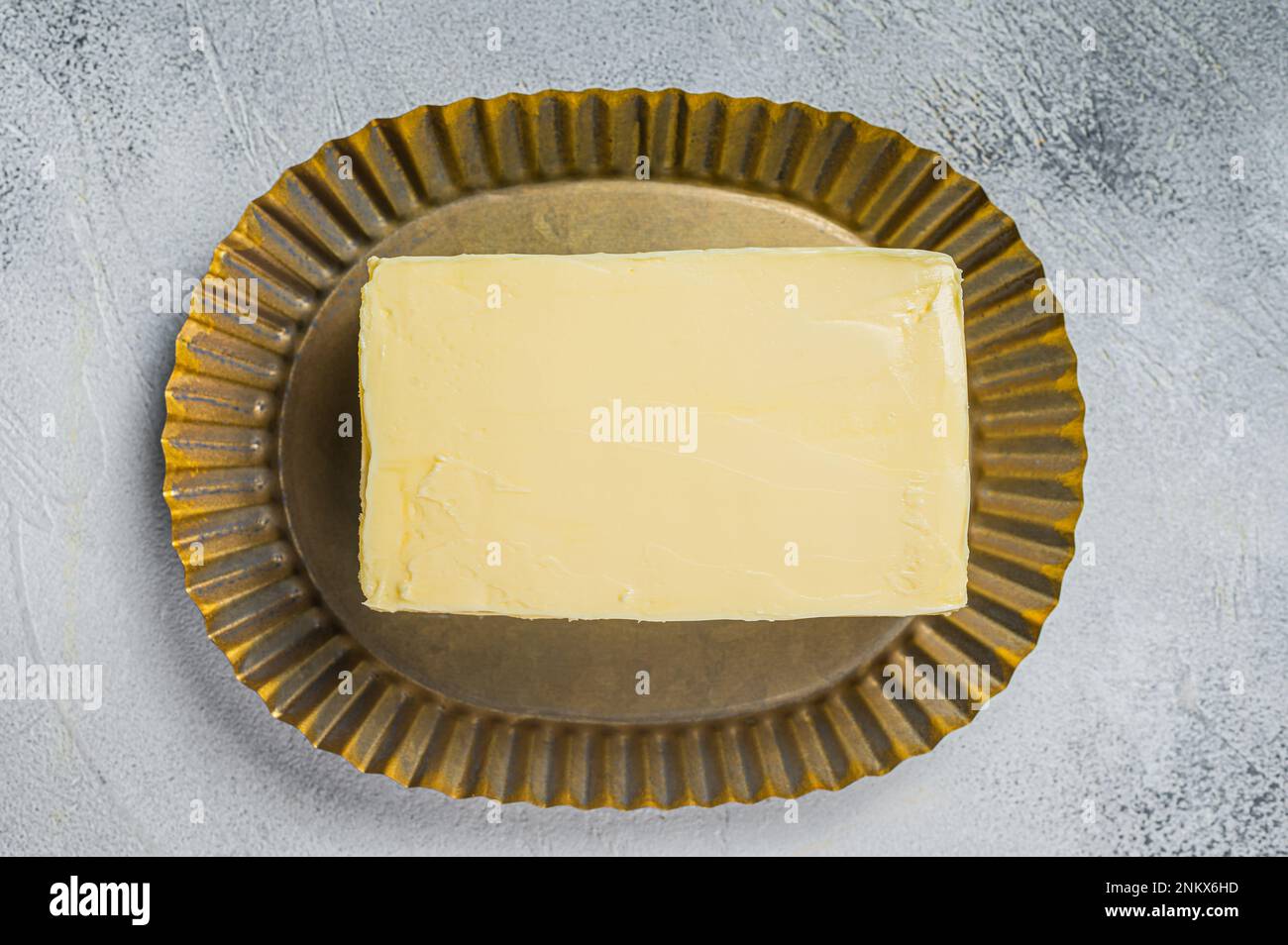 Butter block on steel plate. White background. Top view Stock Photo - Alamy