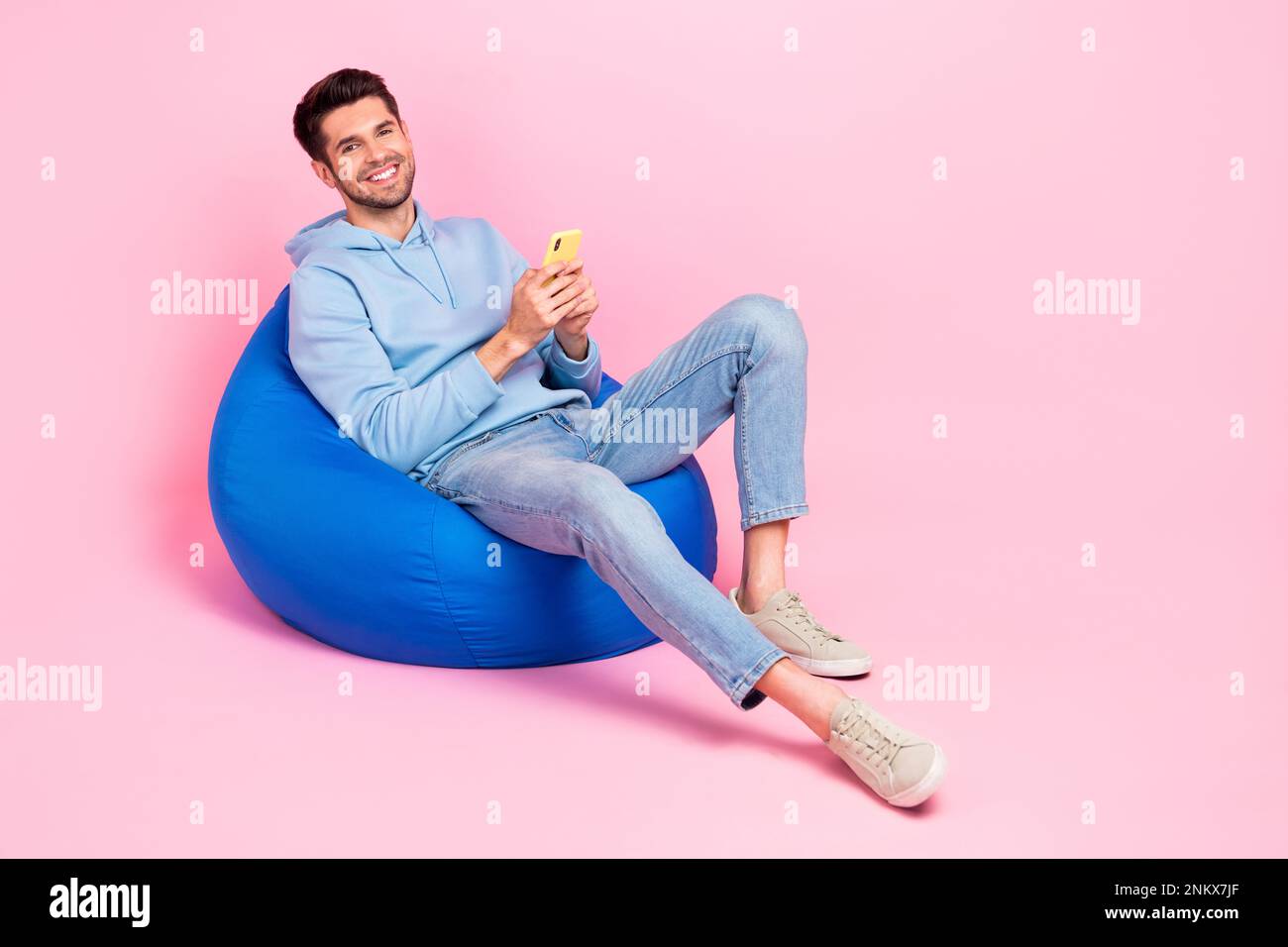 Photo of successful man freelancer sit home use telephone scroll ...