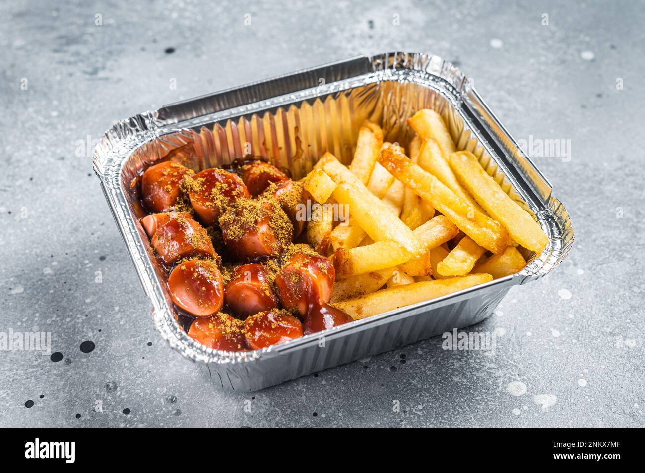Traditional German currywurst with french fry served take away. Gray ...