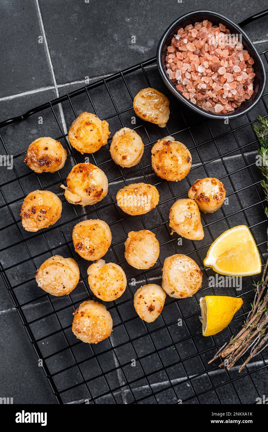 Grilled Scallops fillets on a rack. Black background. Top view Stock ...