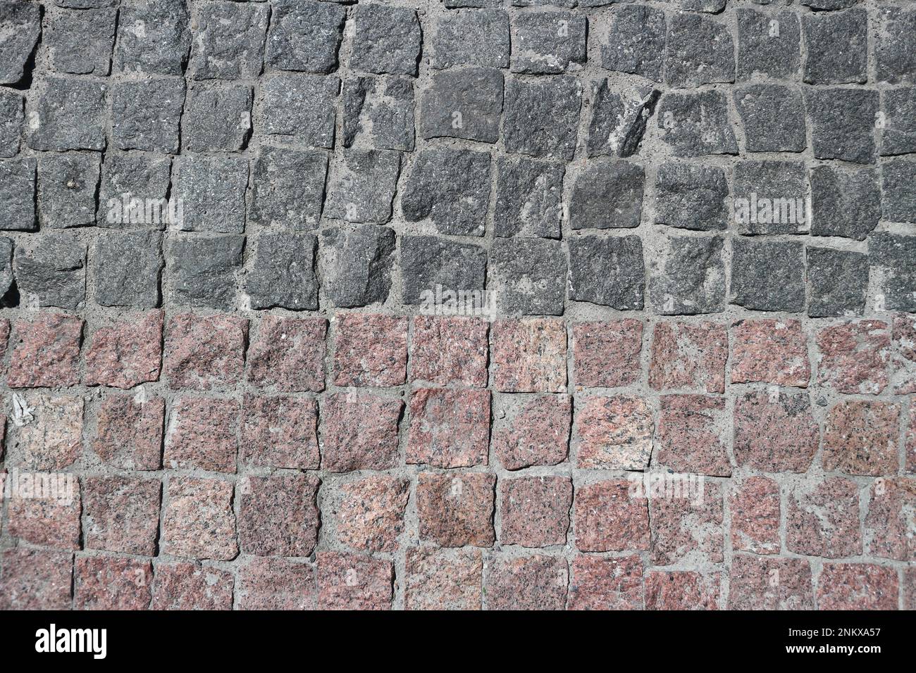 Rubble gray and brown square stones paved road with a horizontal border ...
