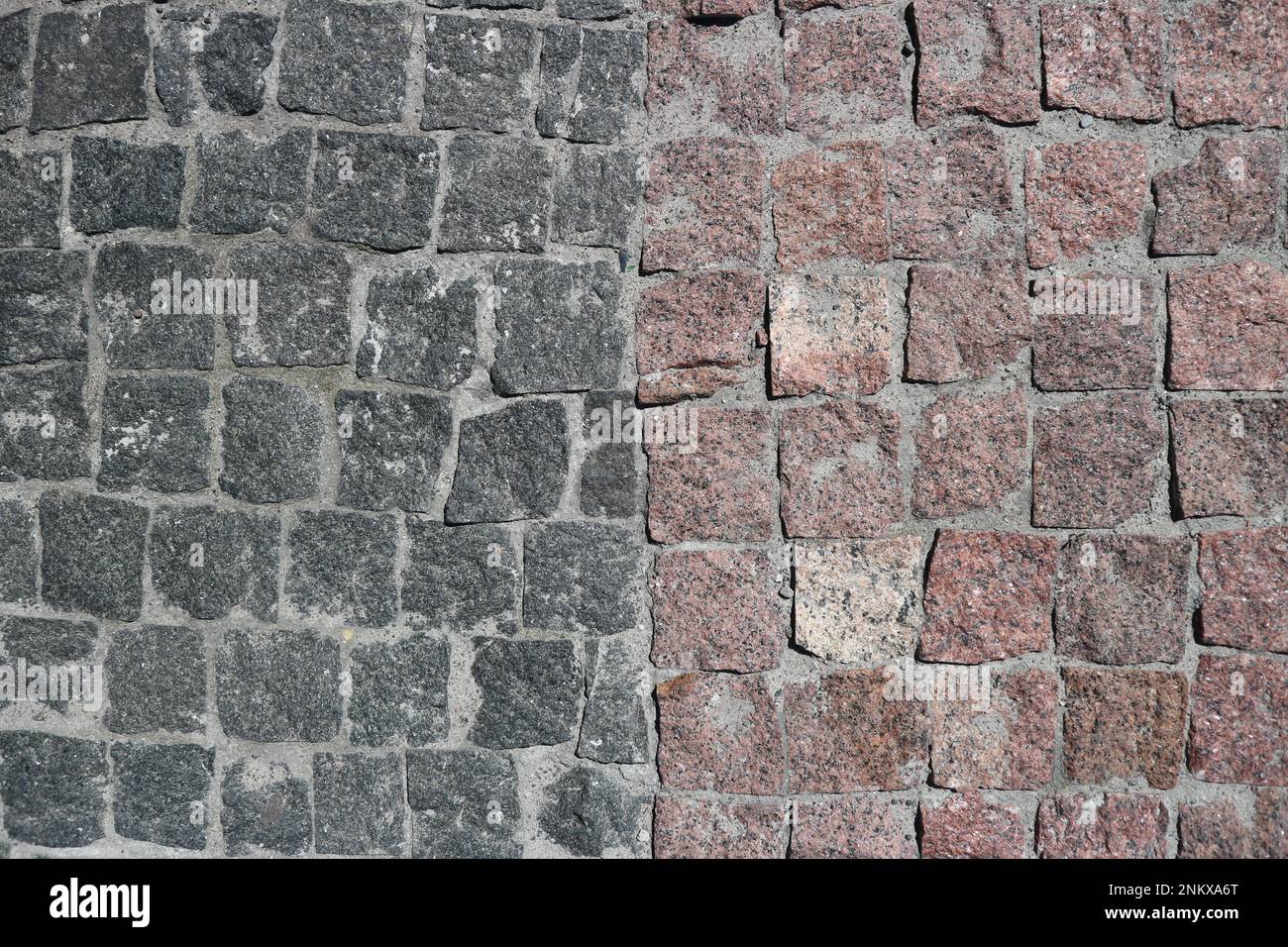 Rubble gray and brown square stones paved road with a vertical border ...