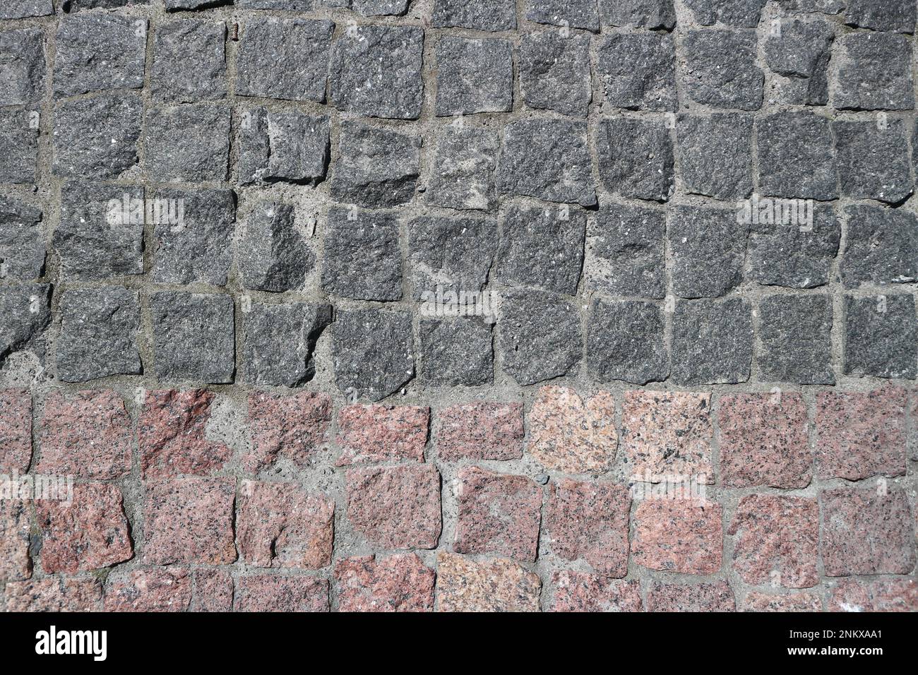 Rubble gray and brown square stones paved road with a horizontal border ...