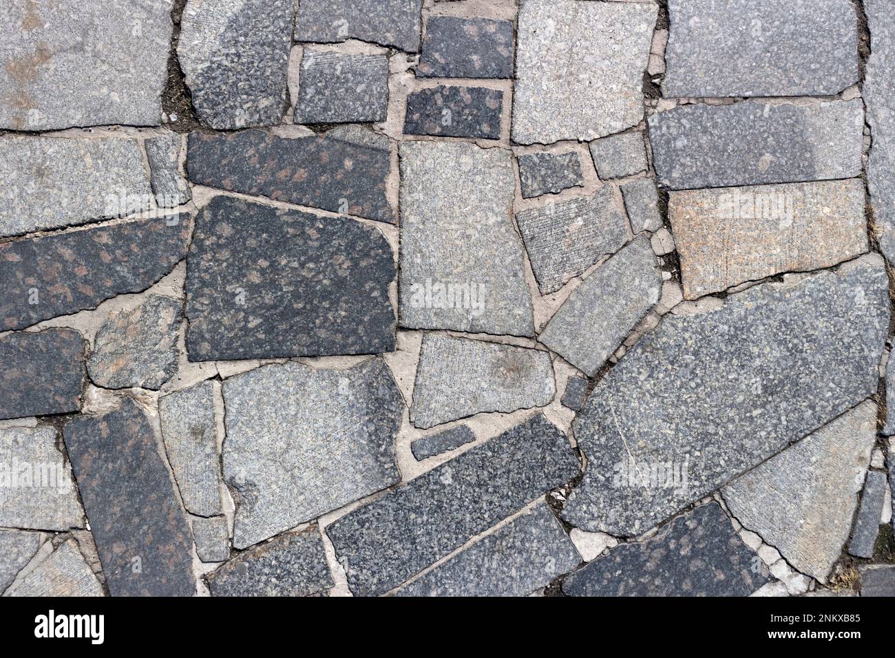 The polished pieces of gray granite paved road Stock Photo - Alamy