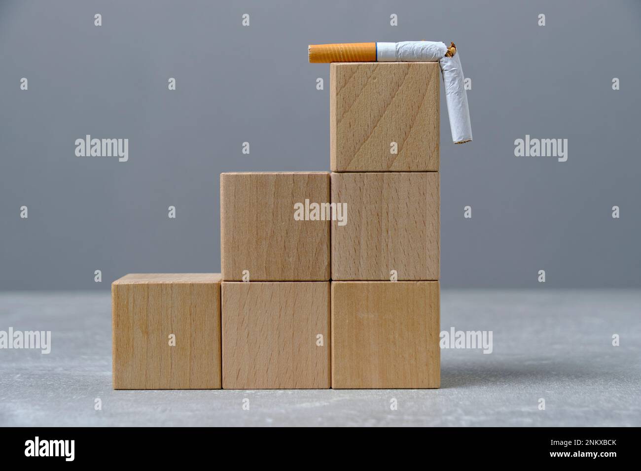 There broken cigarette at top of wooden cube ladder.Concept, World no ...