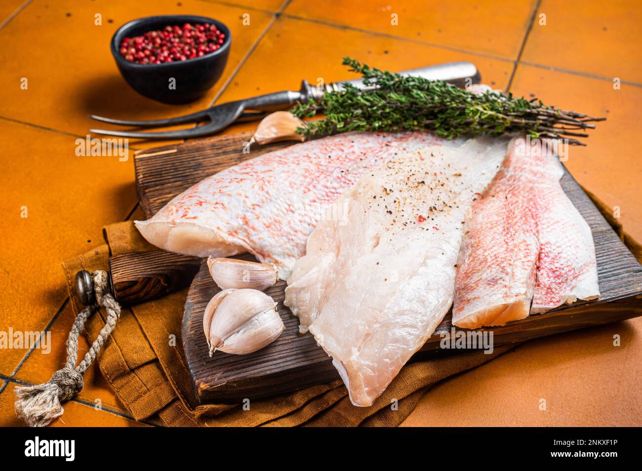 Uncooked ocean red perch fillet, redfish with herbs and spices. Orange ...