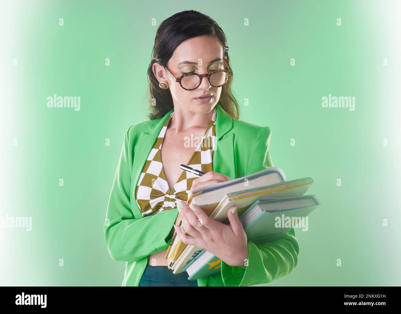 Education, teacher and a woman writing on books isolated on green ...