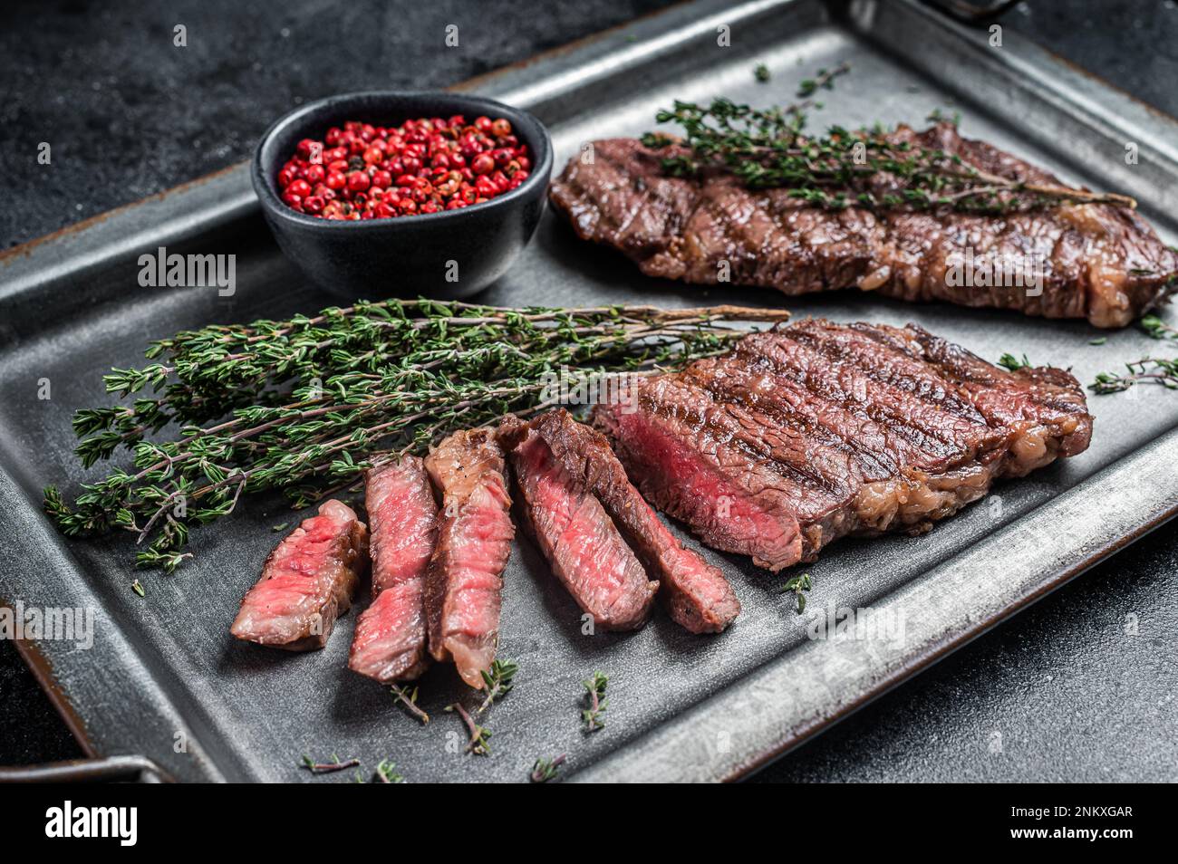 BBQ roast denver top blade beef meat steak on a steel tray with herbs ...