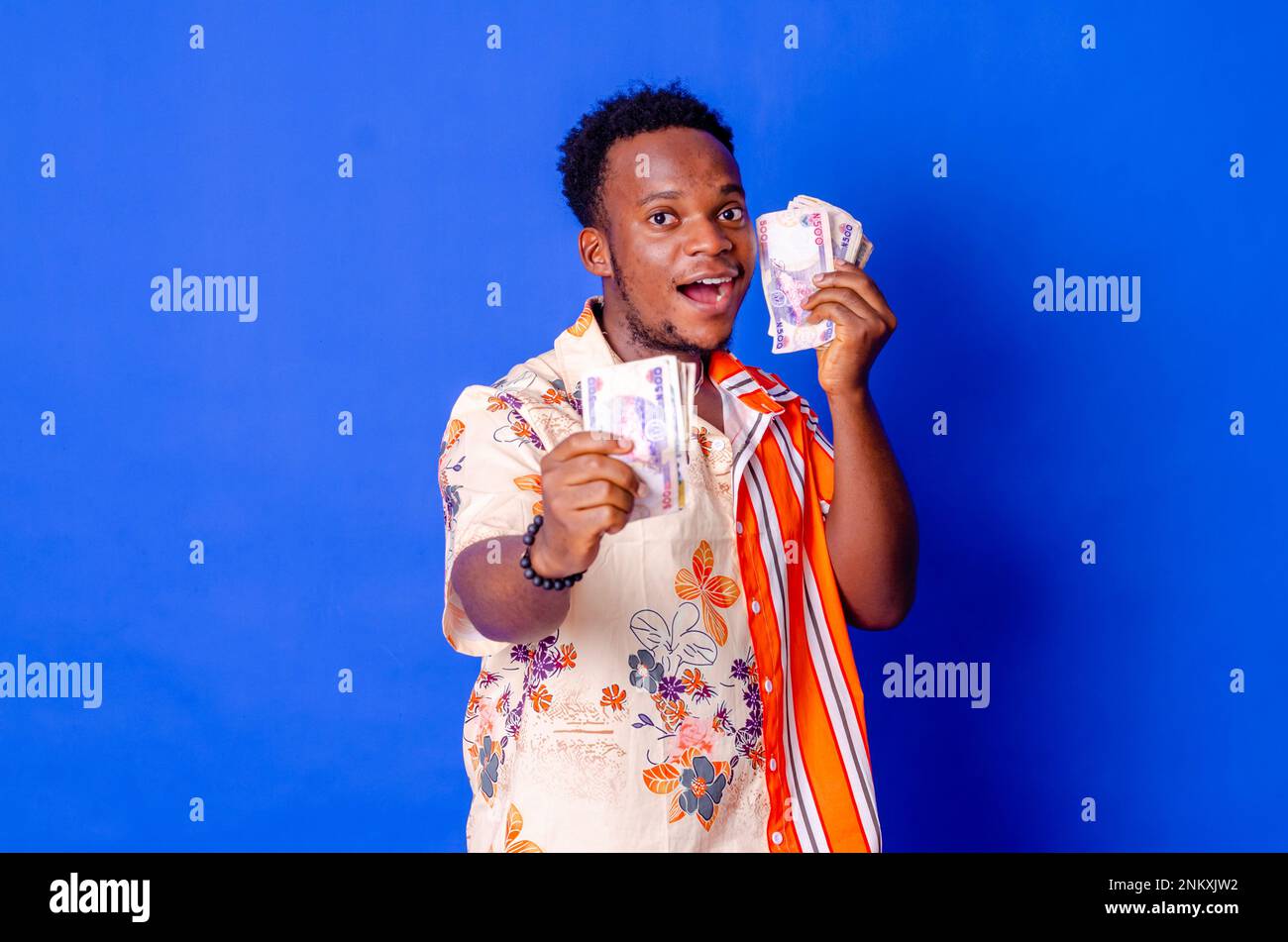 happy and excited young african man holding bundles of cash Stock Photo ...