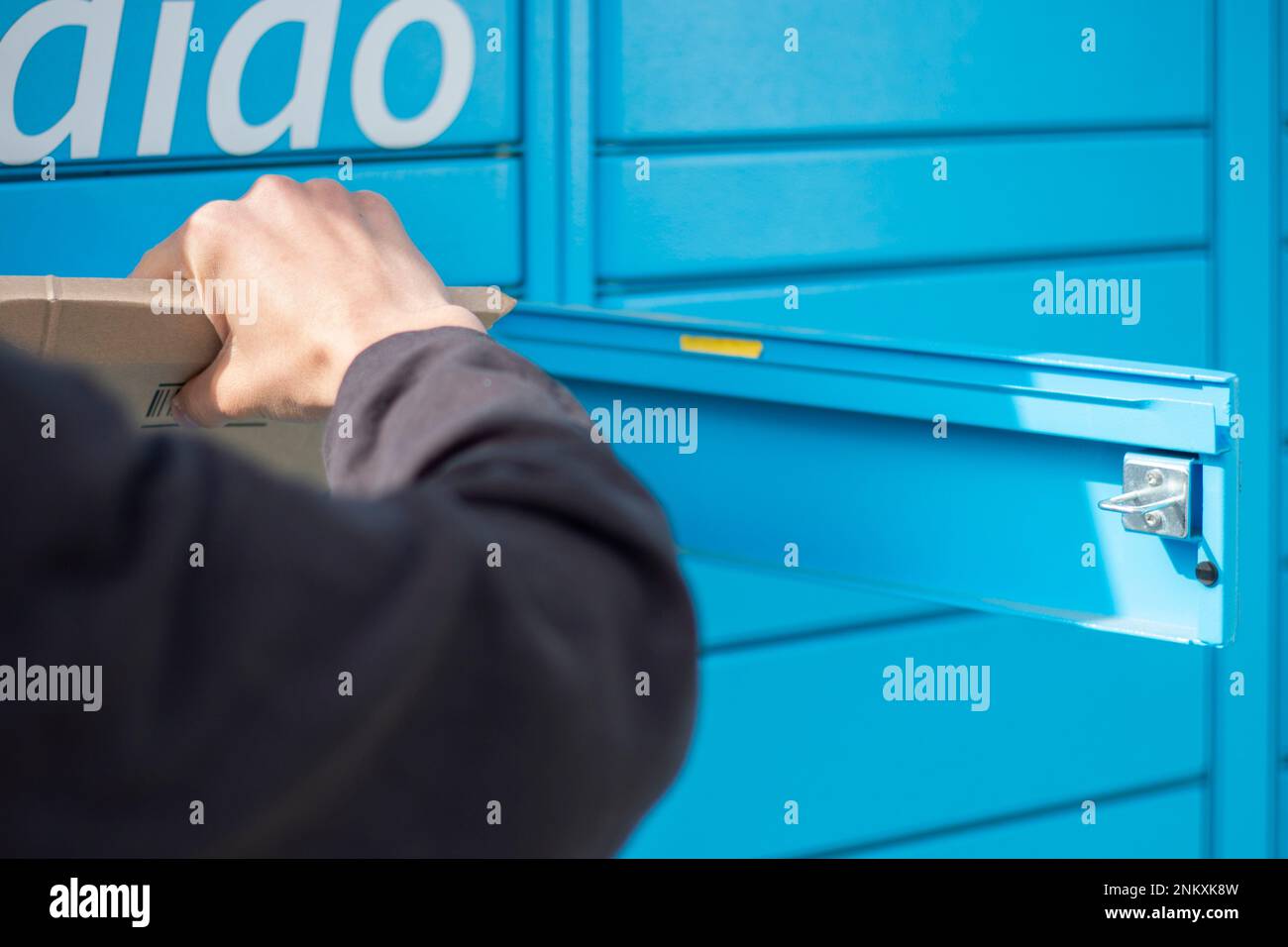 Blue locker. Logistic mailbox a person's hand removes a package Stock ...