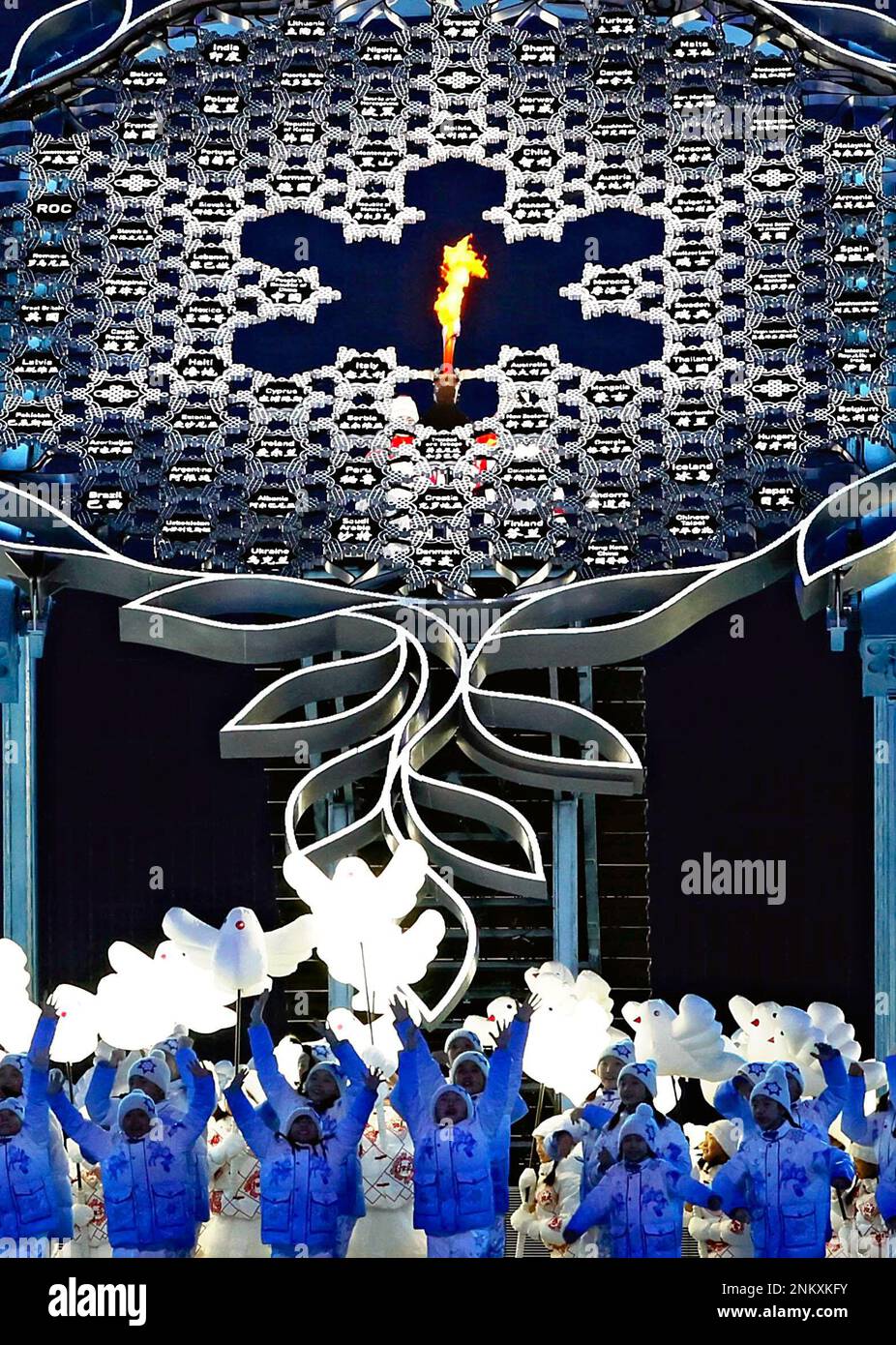 The Olympic torch is placed on the Olympic cauldron during the opening ...