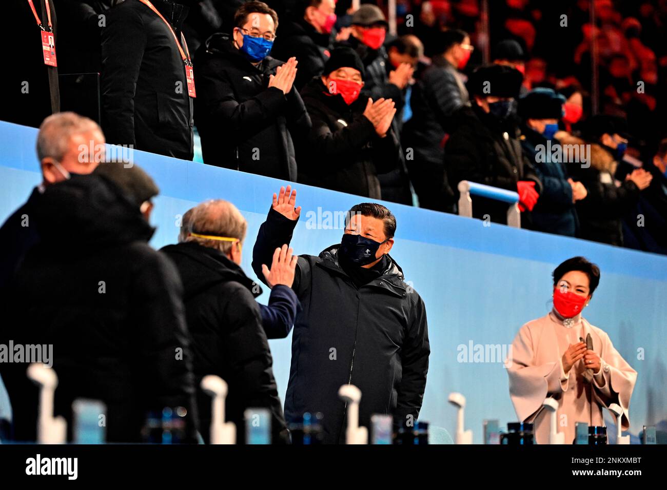 Chinese President Xi Jinping waves to the crowd with his wife Peng ...