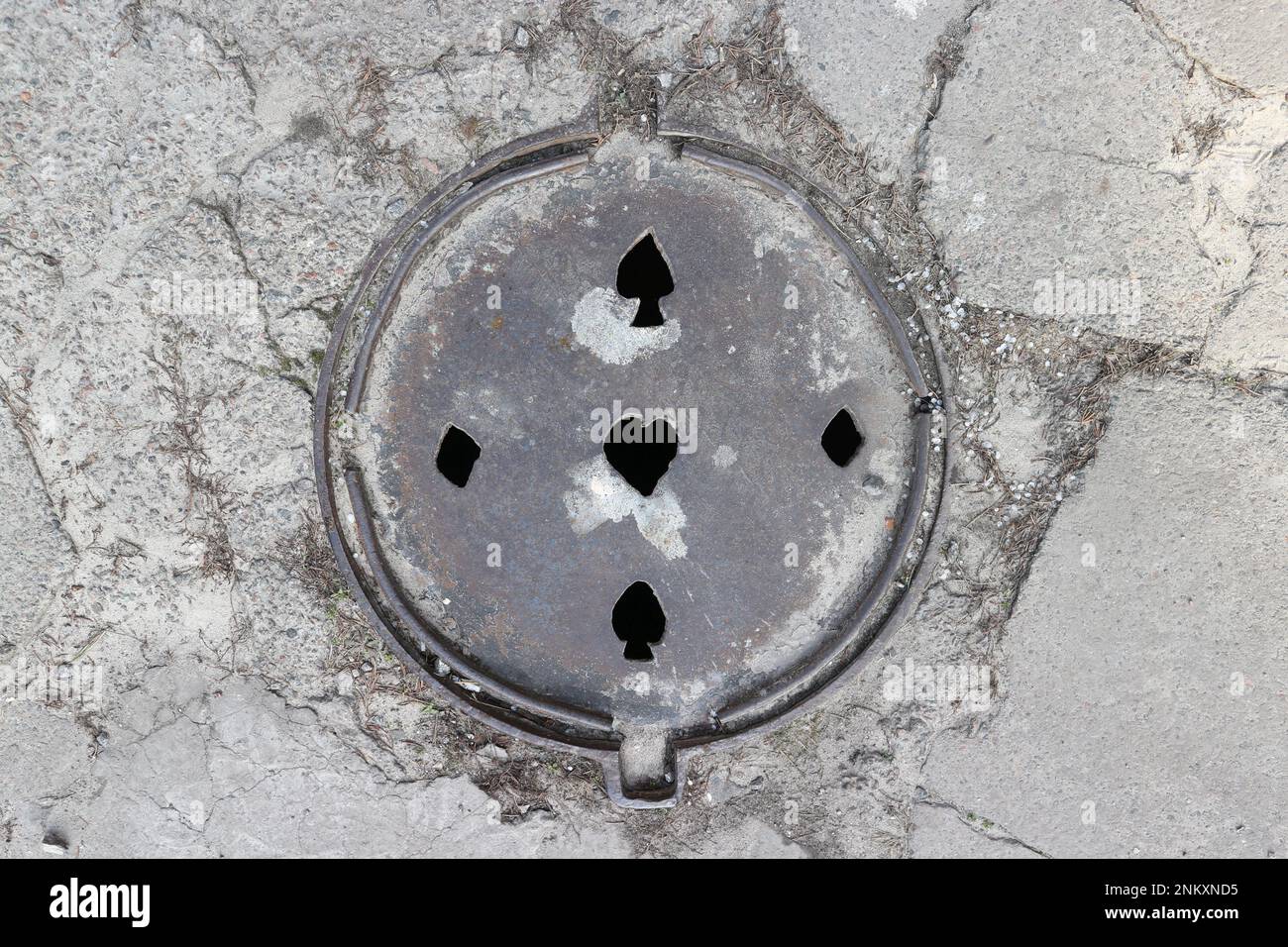 Round metal hatch with holes in the form of card suits (Diamonds ...