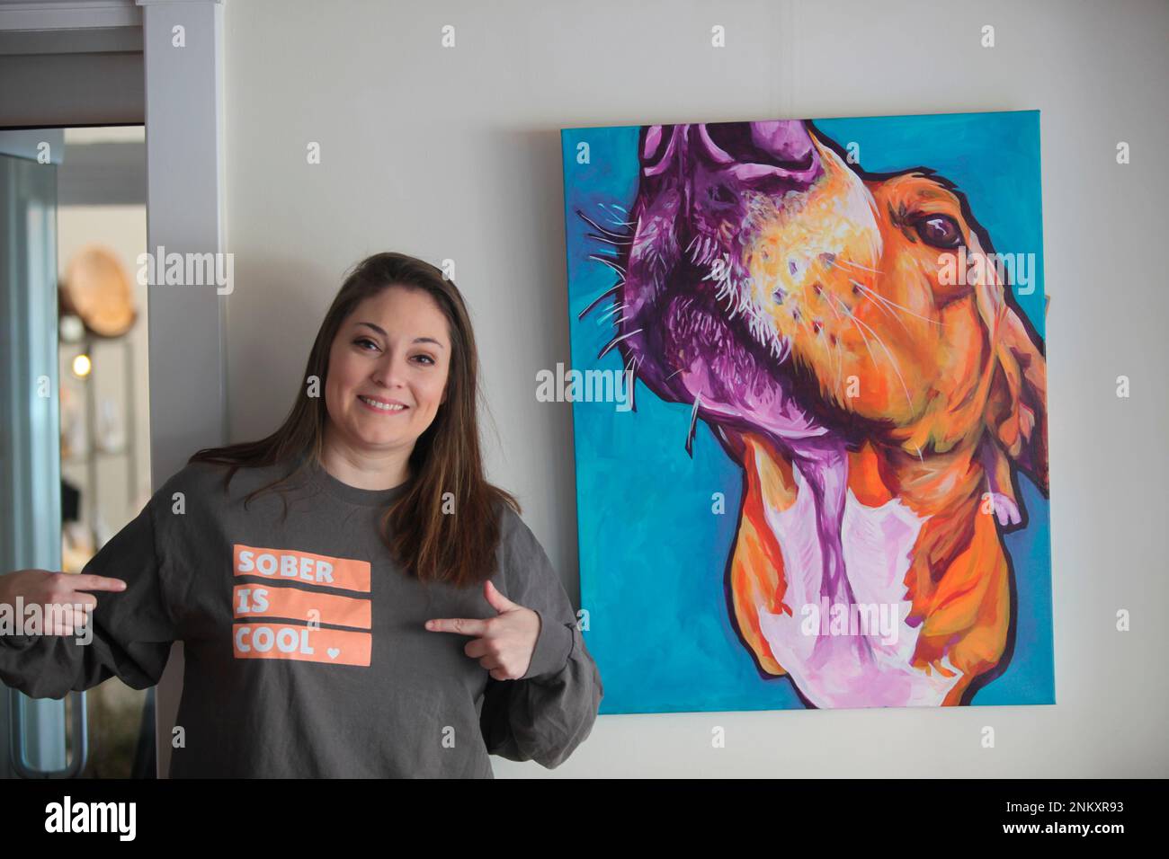 Ellen Morris poses next to one of her paintings at the Shenandoah ...