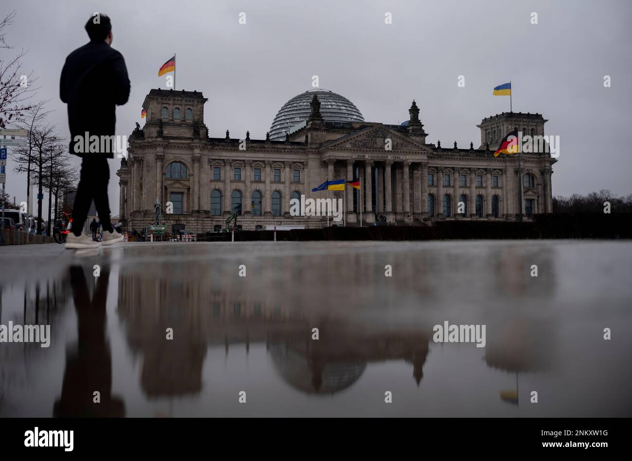 An Ukrainian flag waves on the top and in the front of the German ...