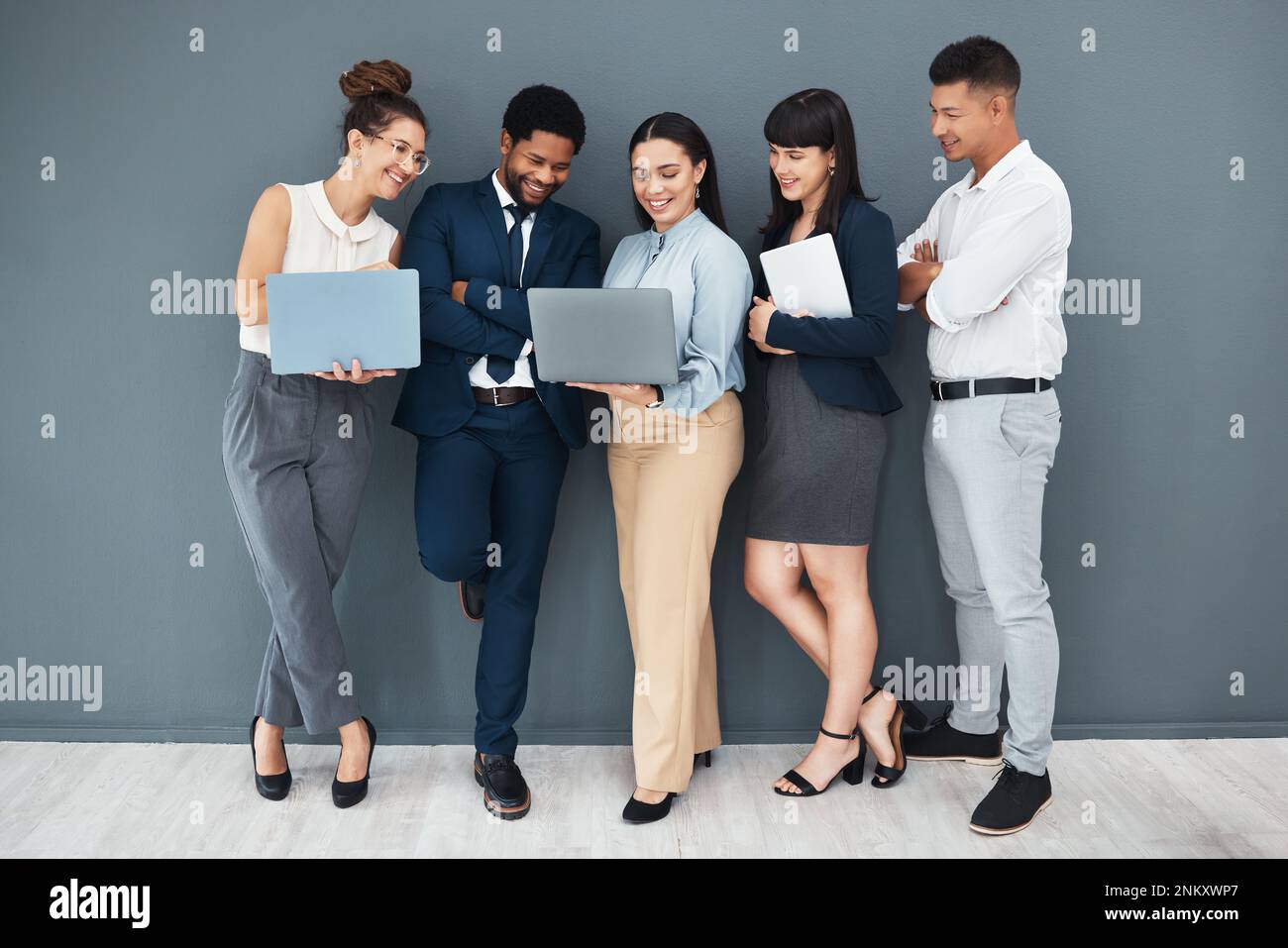 Business, teamwork and laptop on wall background for planning, strategy ...