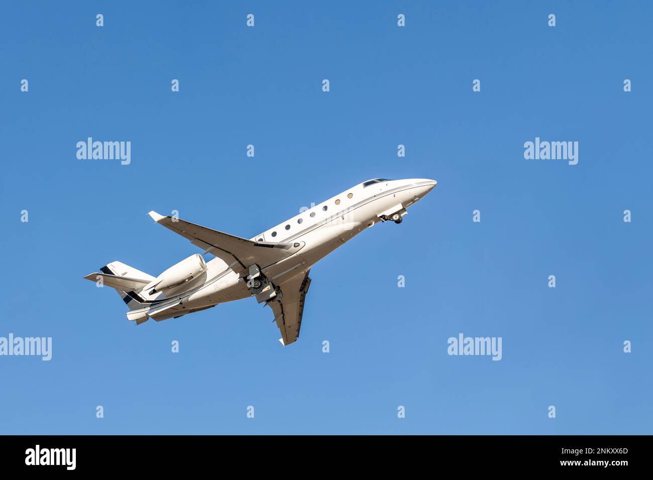 Scenic close bottom view modern luxury expensive white private jet ...