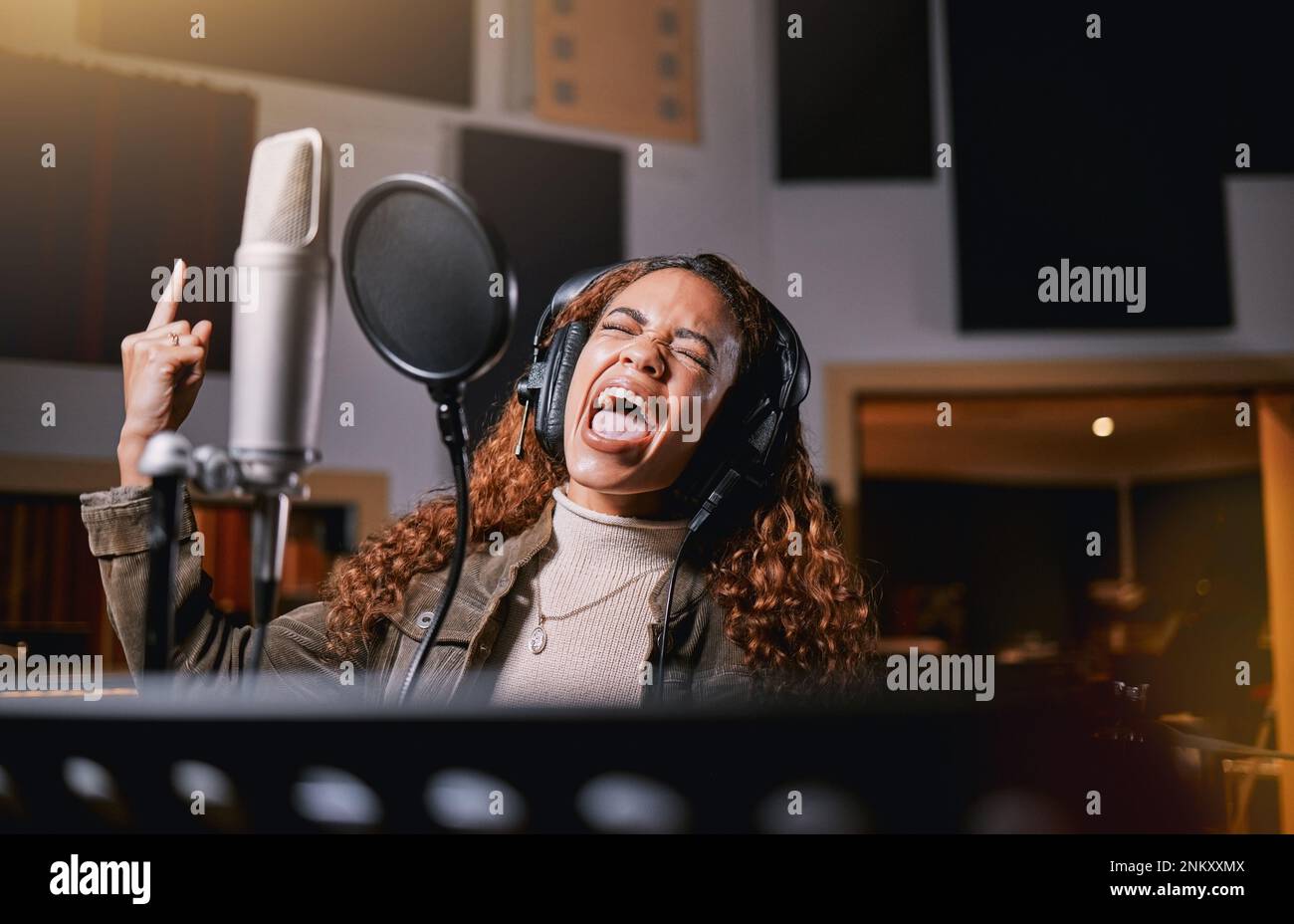 Music, singing and radio with a black woman celebrity at her record ...