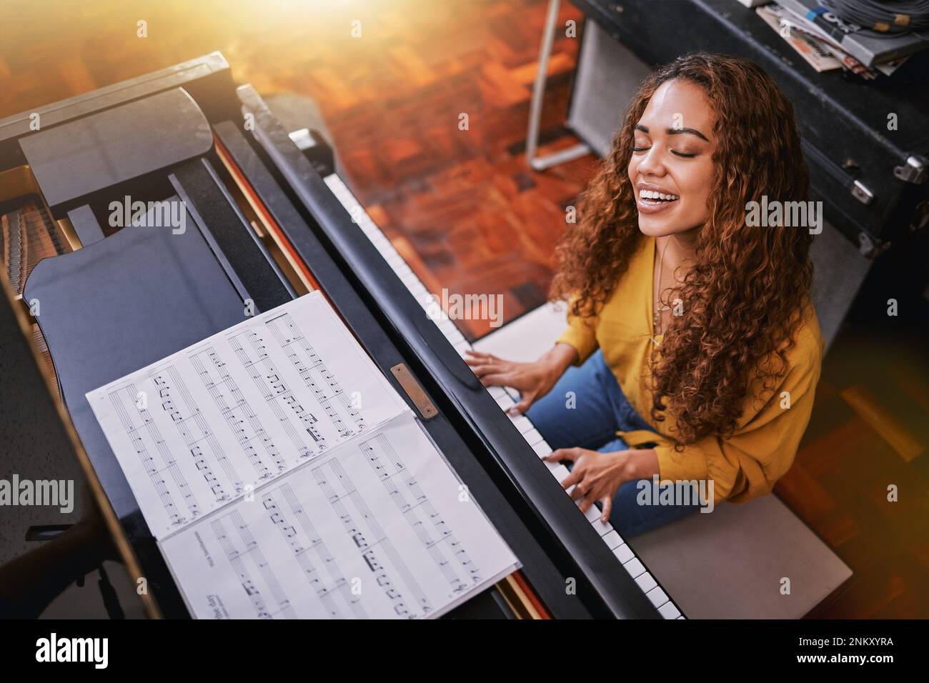 Woman, singing and playing piano with music notes and a smile in home ...