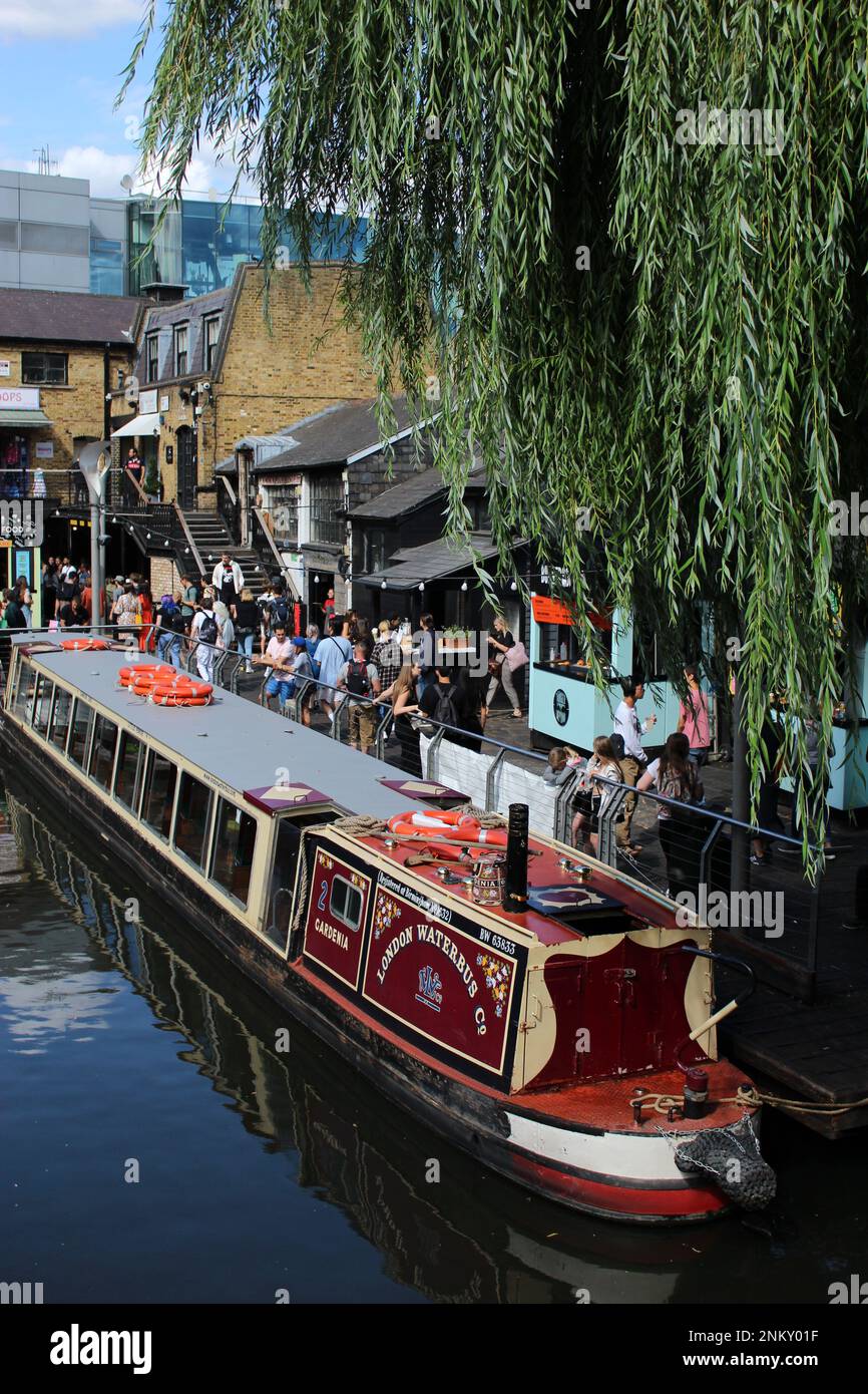 Lush green willow tree and beautiful canal boat in Camden Lock Market ...