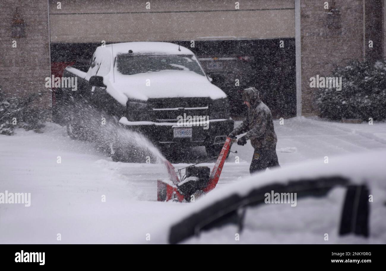 Matt Seggerman get's an early start on removing snow from his driveway ...