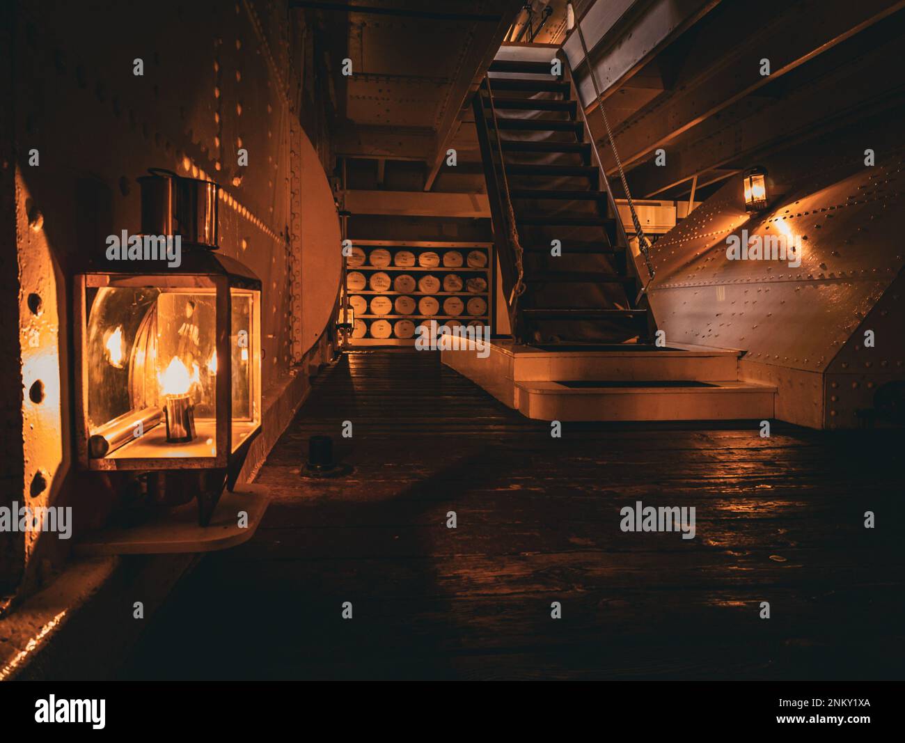 Interior of HMS Warrior ship lit by dim light with stairwell visible ...